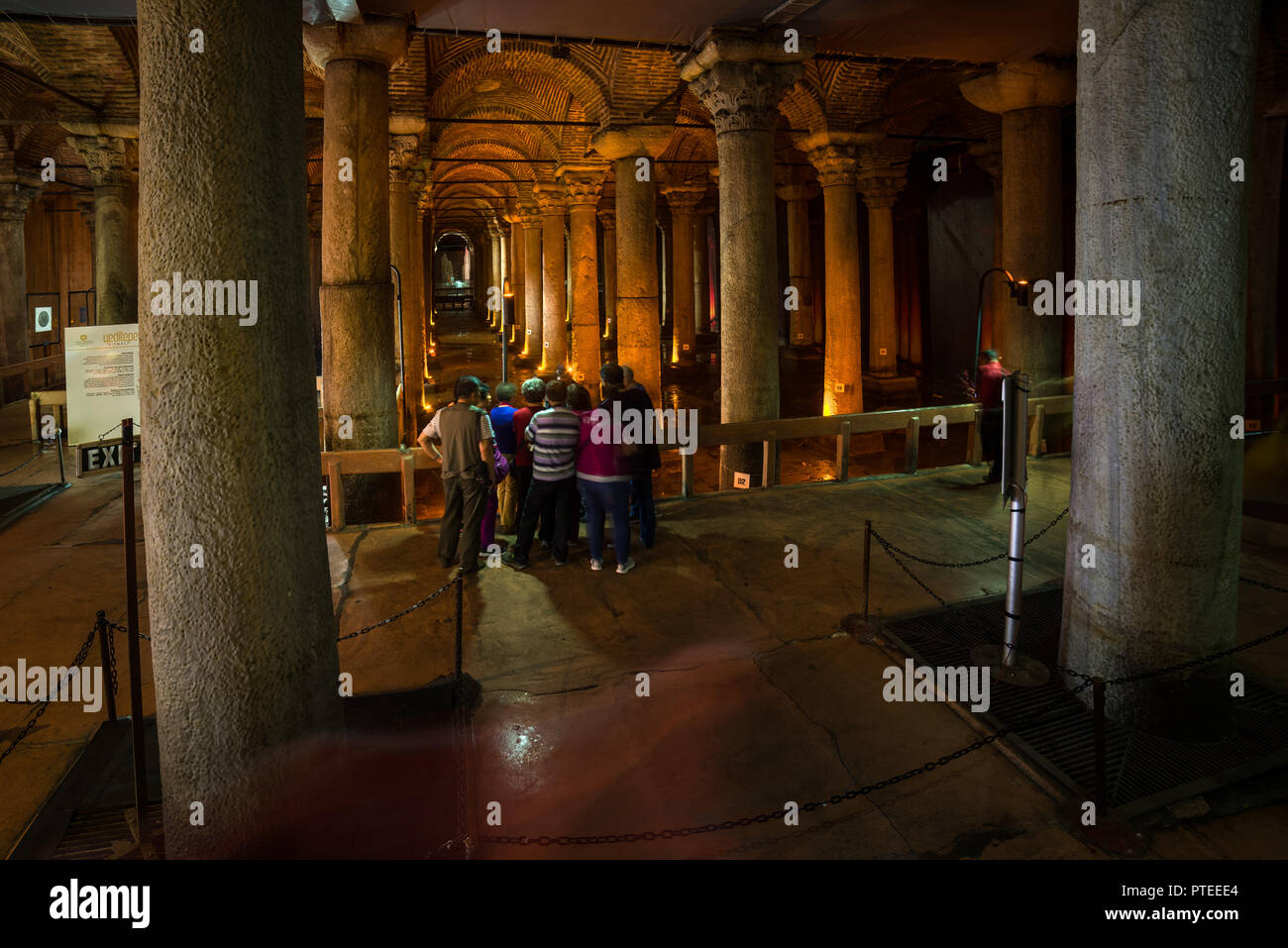 A group of tourists standing in the ancient Roman Basilica Cistern or ...
