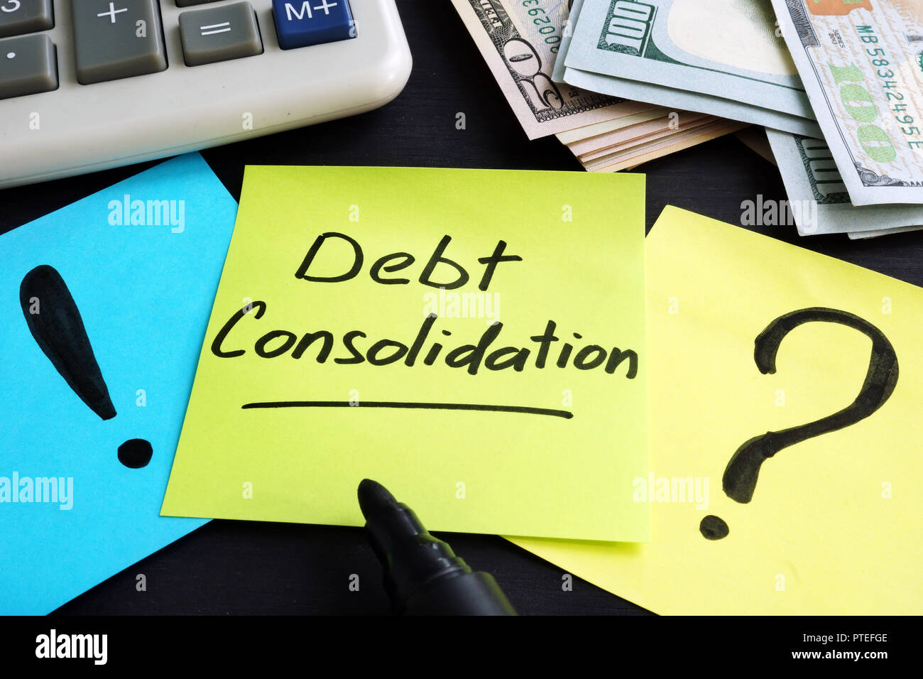 Debt consolidation written by hand and money Stock Photo - Alamy