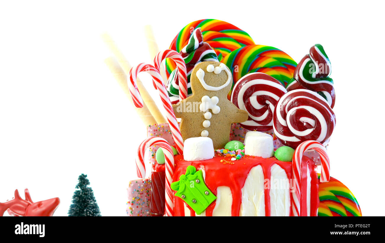 On trend festive candyland Christmas drip cake on white background ...
