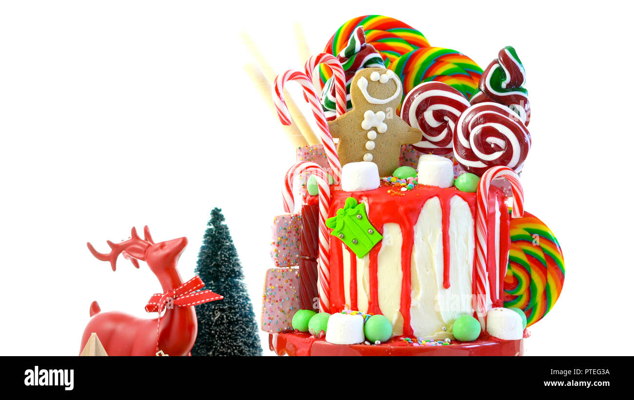 On trend festive candyland Christmas drip cake on white background ...