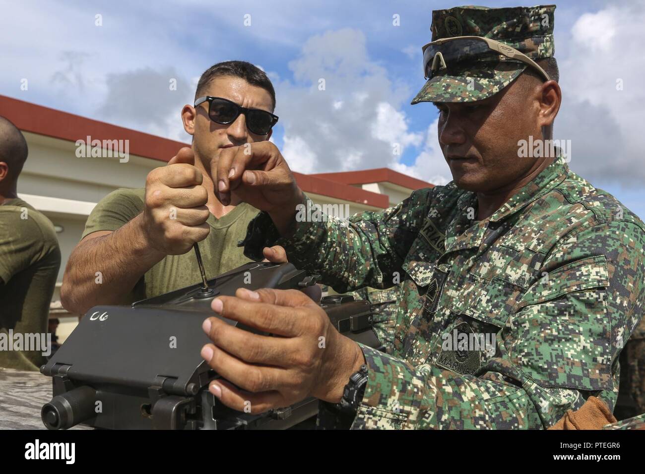 U.S. Marine Lance Cpl. Andrei B. Greenfield, left, breaks down a weapon ...