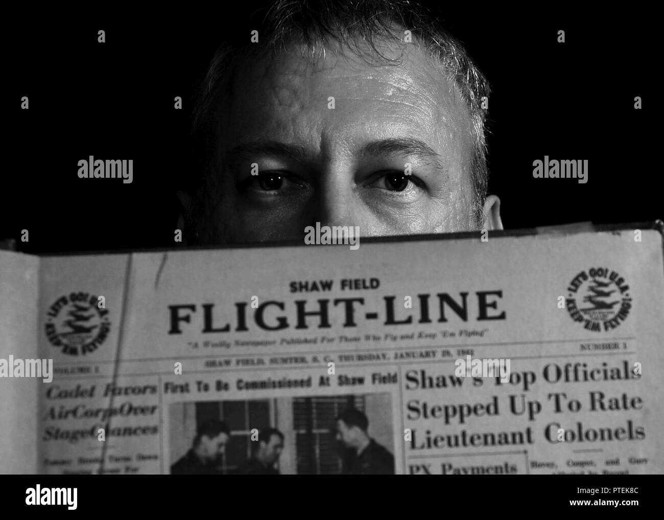 Christopher Koonce, 20th Fighter Wing historian, holds a 1942 edition ...