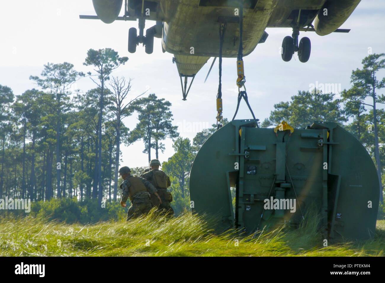 A Ch-53 Super Stallion lifts an Improved Ribbon Bridge during ...