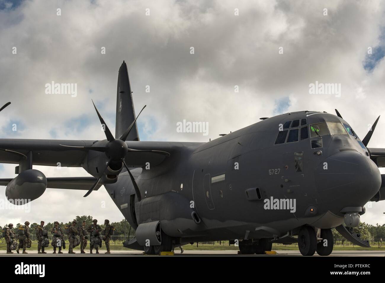 Airmen from the 820th Base Defense Group enter an HC-130J Combat King ...