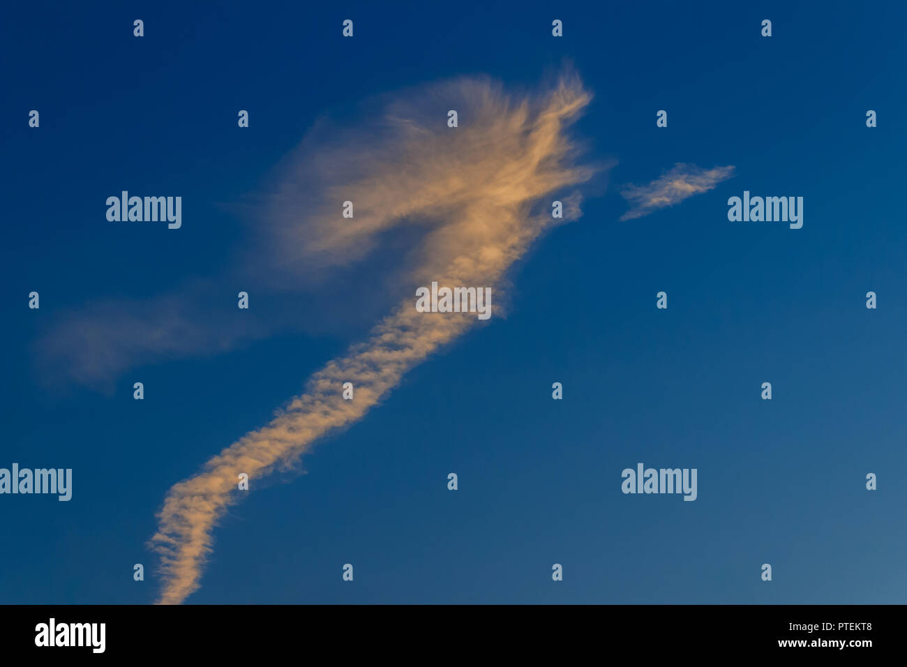 Blue sky with smoke contrail from a rocket or airplane. White cloud ...