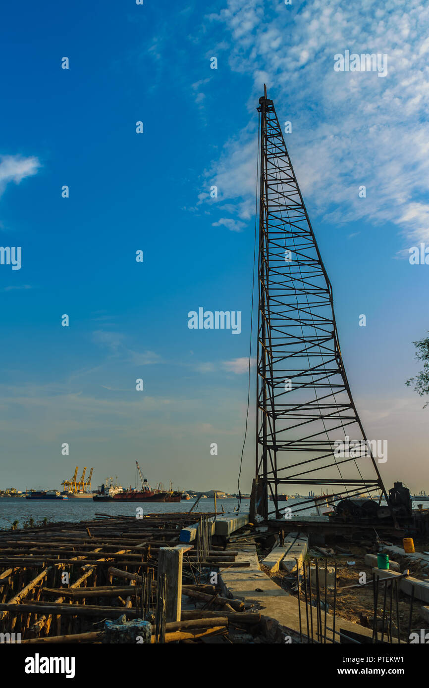 Pile driving machine with reinforced concrete piles at jetty ...