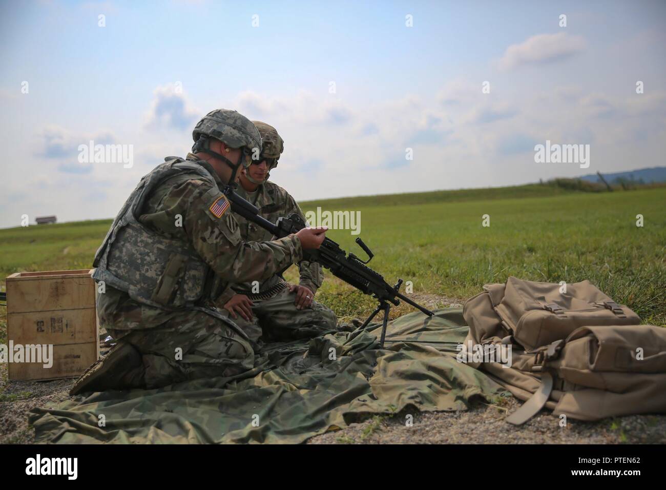 U.S. Army Staff Sgt. Jared Casey conducts clearing procedures on a M249 ...
