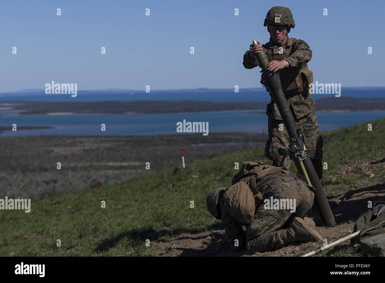 Lance Cpl. Quentin Propson prepares to drop an 81-mm mortar shell as ...