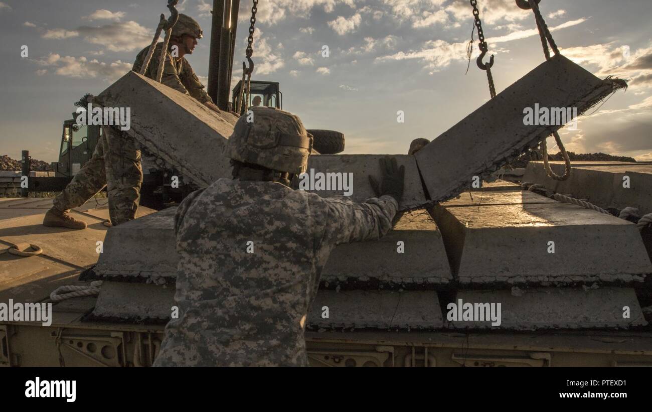 U.S. Army Reserve and U.S. Army National Guard Soldiers work together to move building materials ...