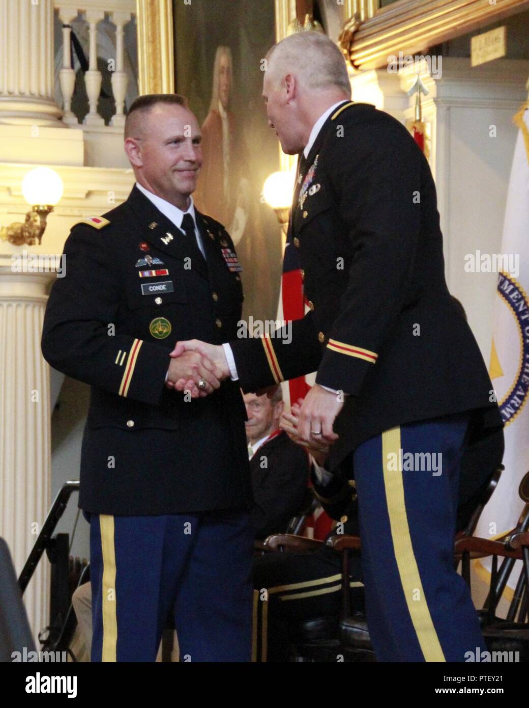 U.S. Army Col. Christopher Barron, congratulates Col. William M. Conde ...