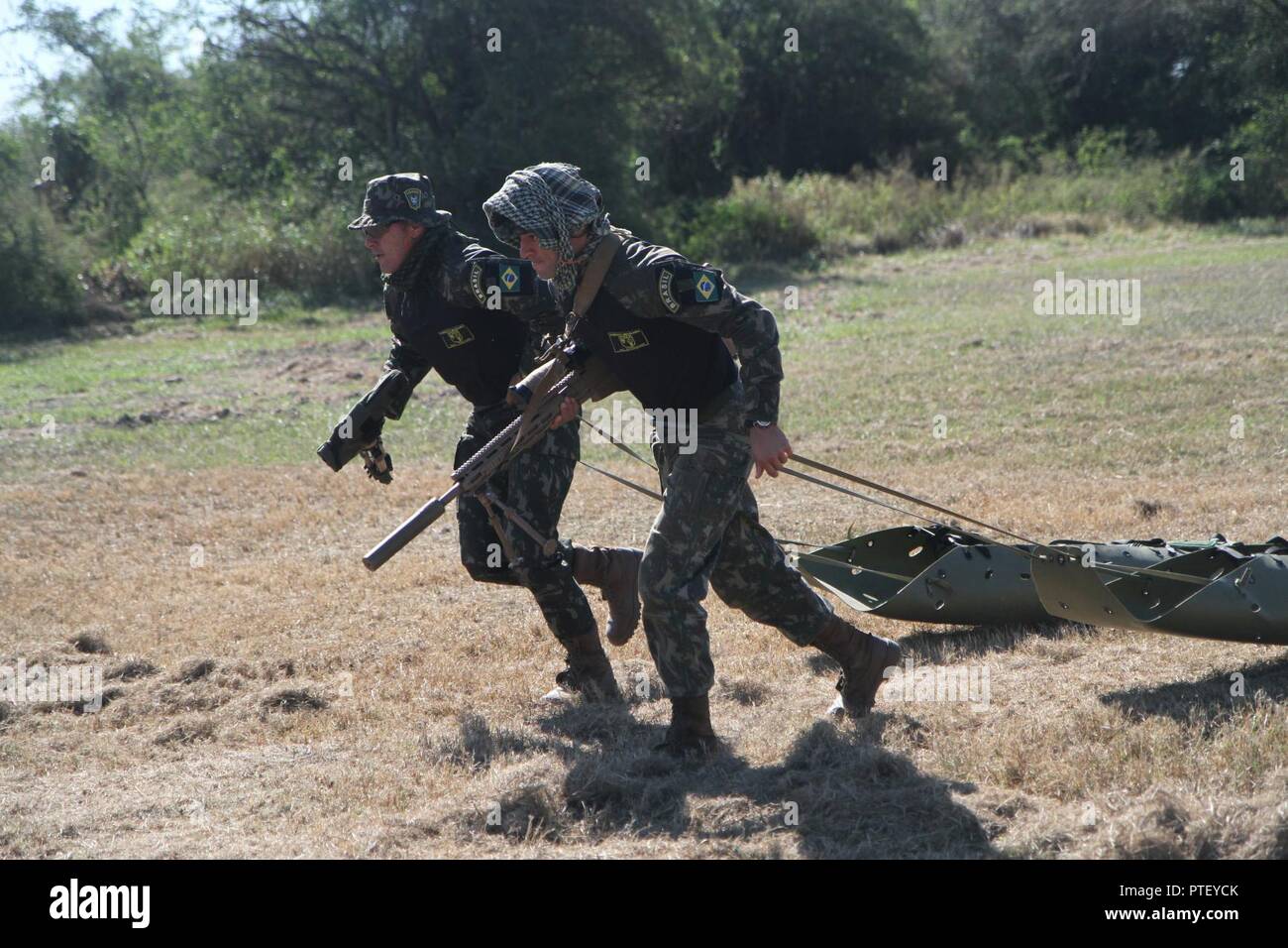 A Brazilian sniper team performs a "body drag" during Fuerzas Comando's ...