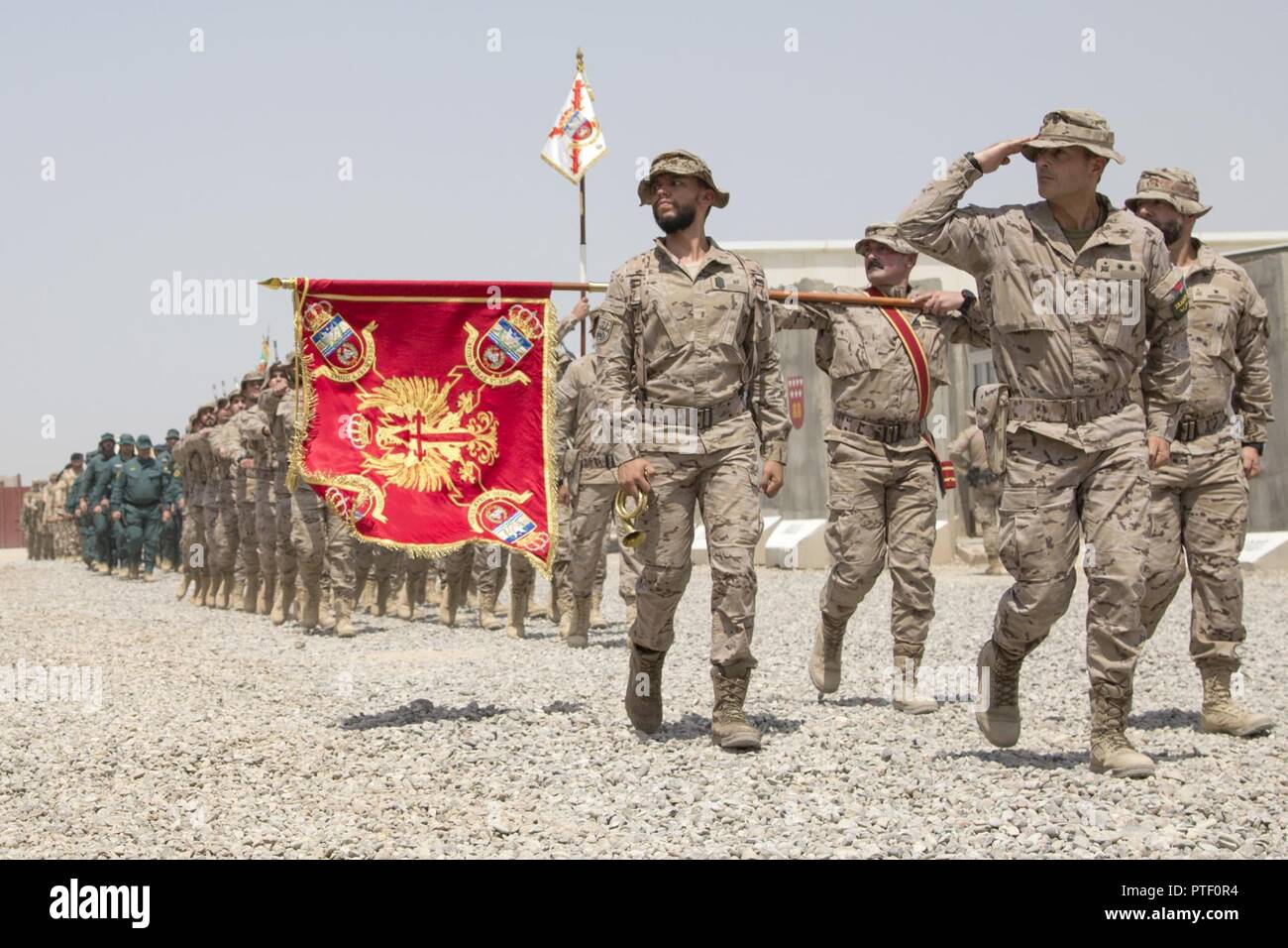 The Spanish army render a salute with hand and guideon as they march ...