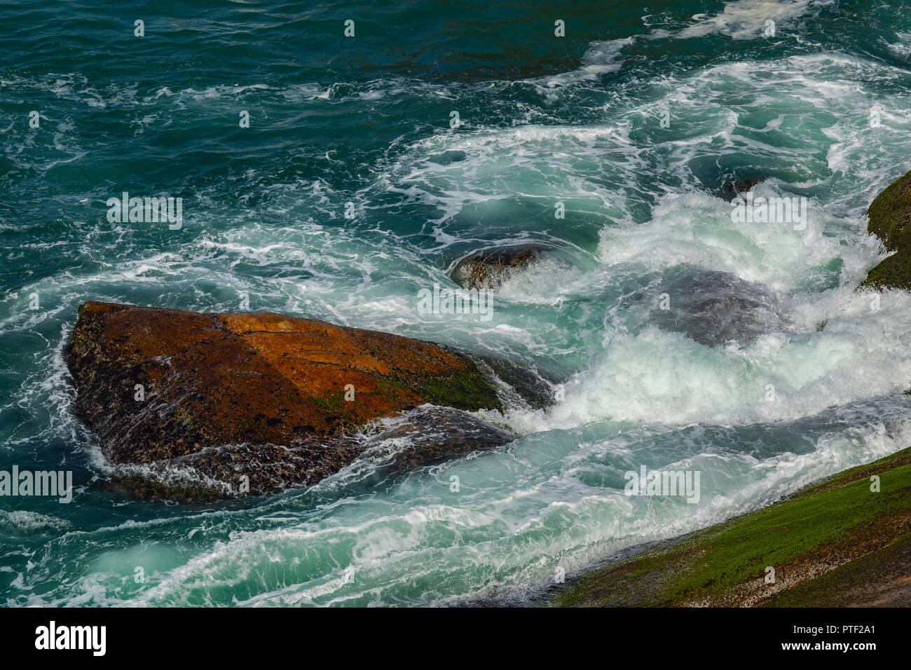 Sea waves breaking on a rocks in Brazil. Deep blue sea waves hit cliff ...