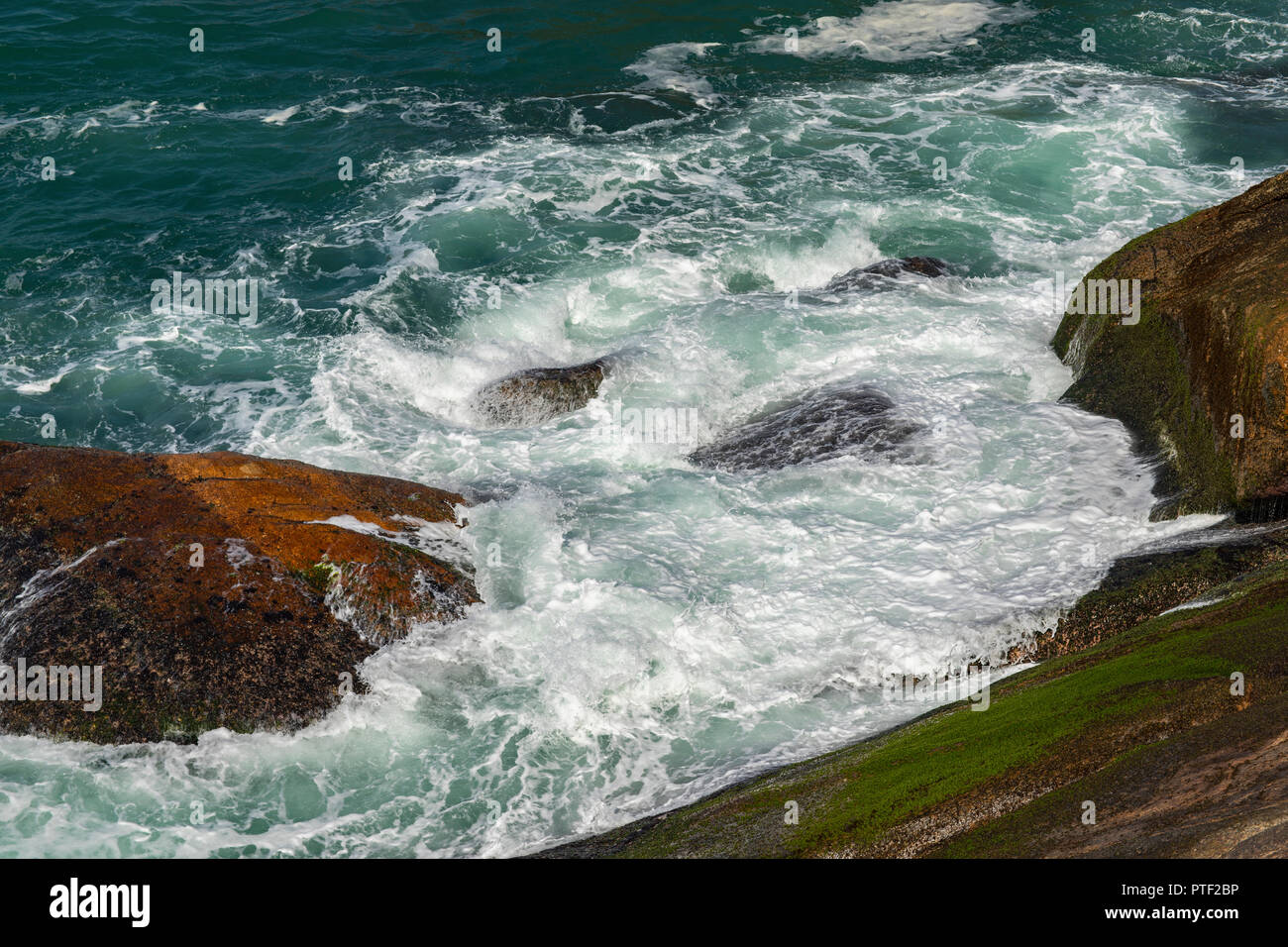 Sea waves breaking on a rocks in Brazil. Deep blue sea waves hit cliff ...