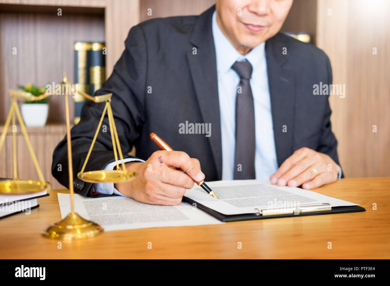 lawyer judge reading documents at desk in courtroom working on wooden ...