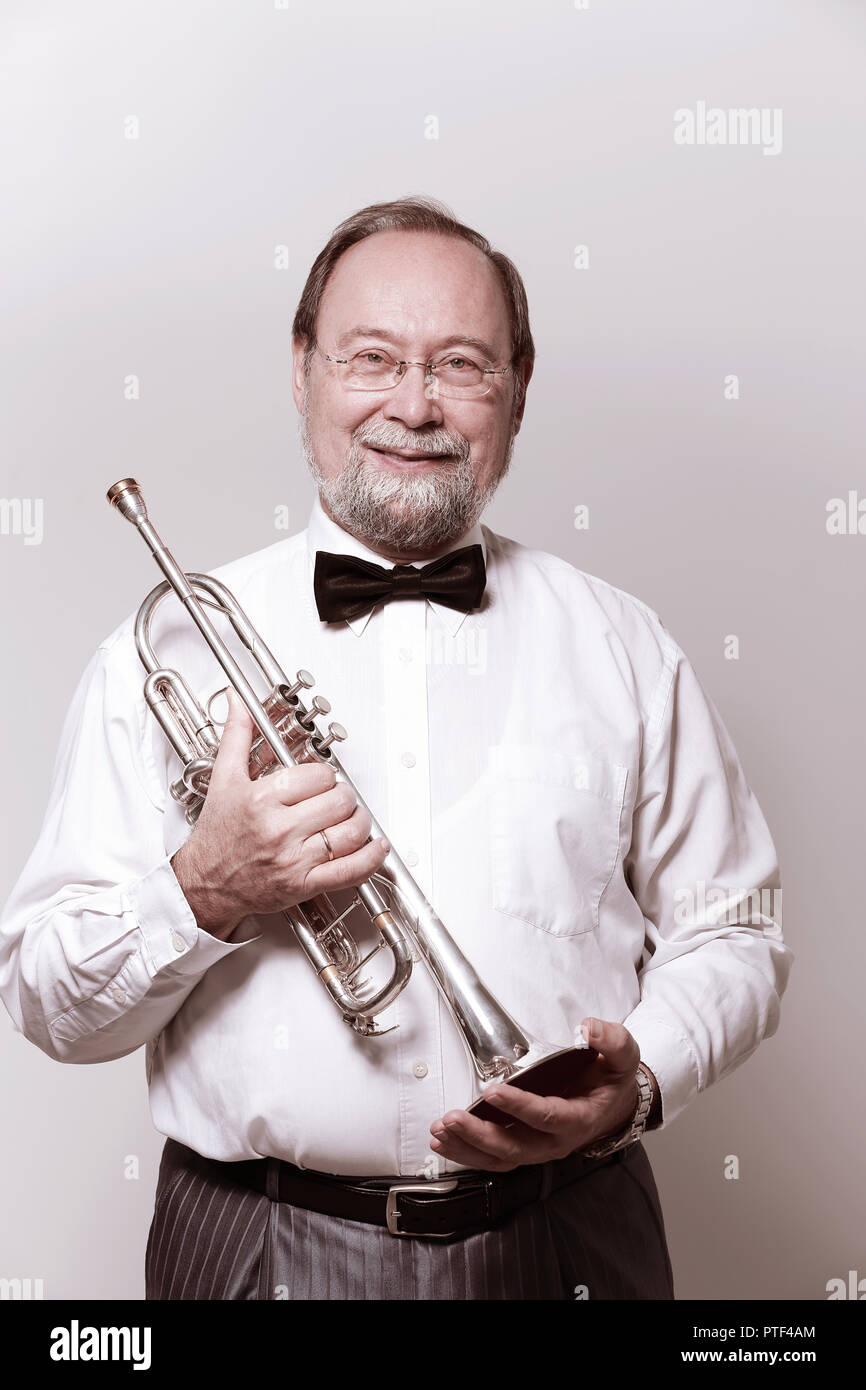 portrait.smiling adult man musician with a trumpet Stock Photo - Alamy