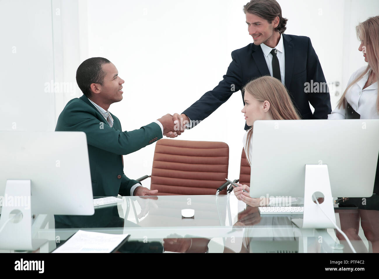 closeup .the handshake between colleagues in the workplace Stock Photo ...