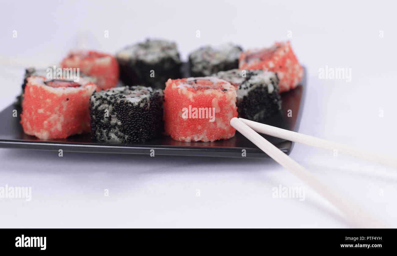 Sushi Set - different types of Maki sushi on a black plate Stock Photo ...
