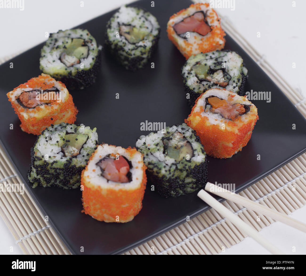 Sushi Set - different types of Maki sushi and chopsticks on a b Stock ...