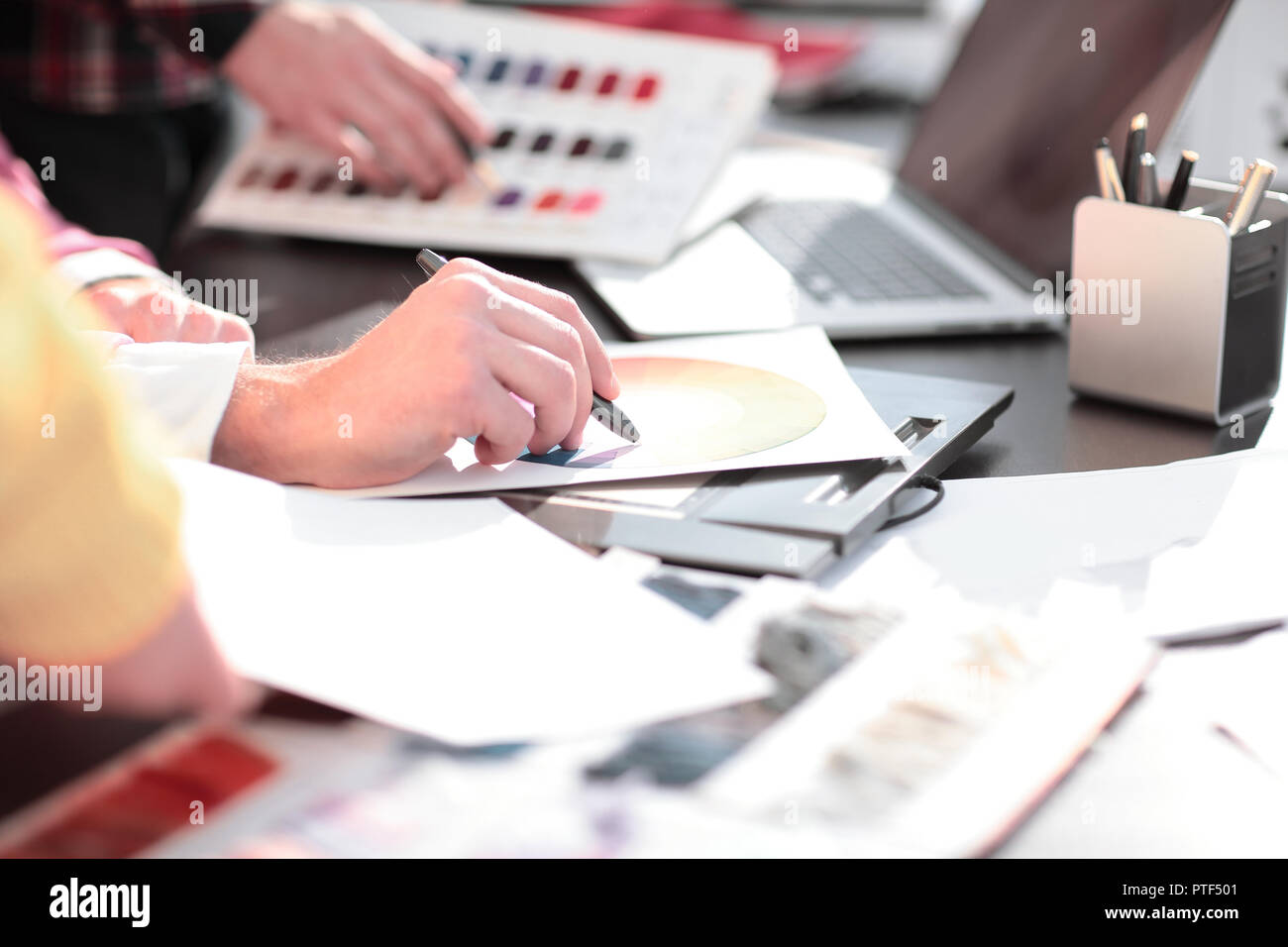 close up.designer working at office Desk with blueprints for a n Stock ...