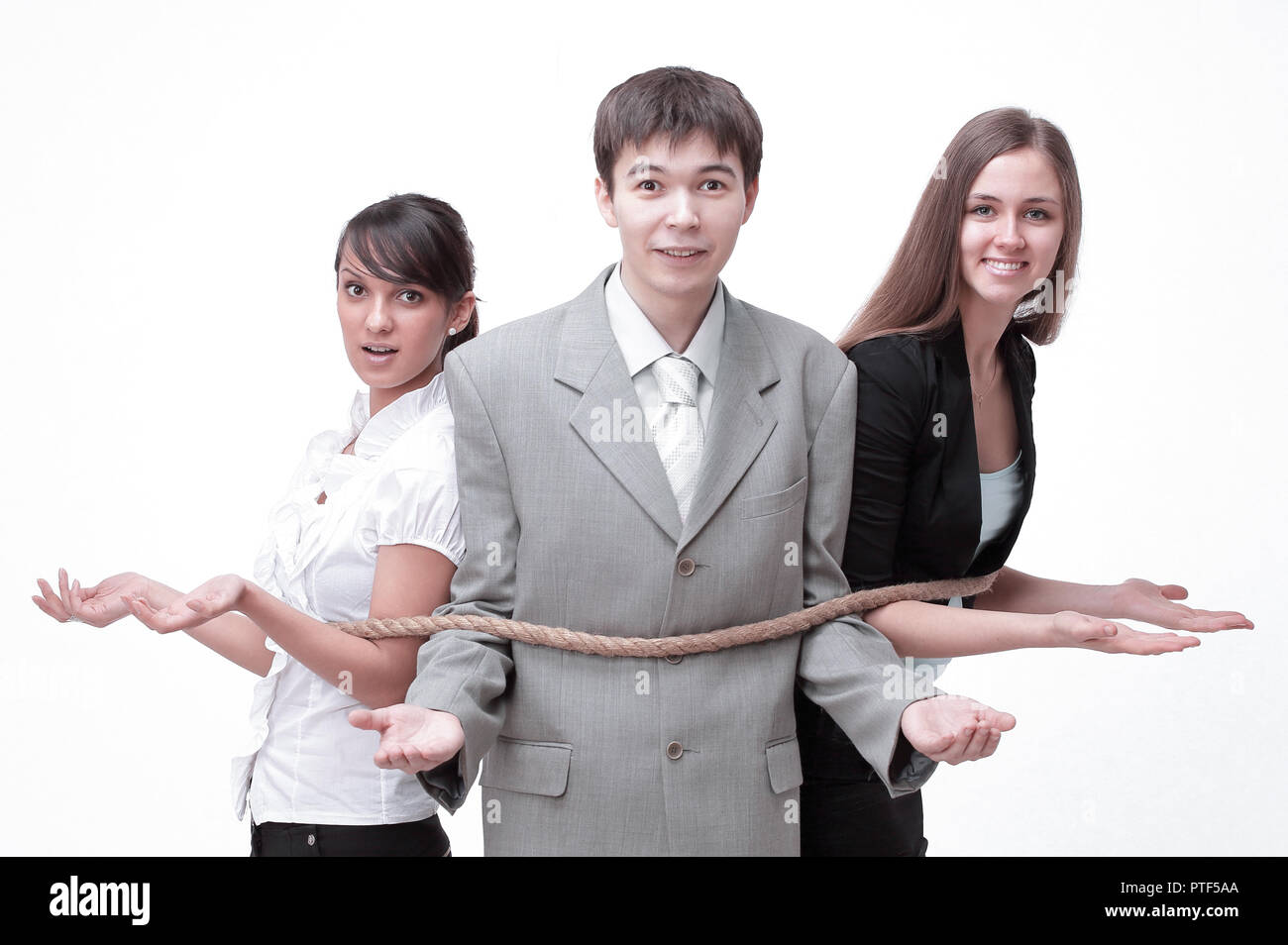 Young business people tied up together against Stock Photo - Alamy