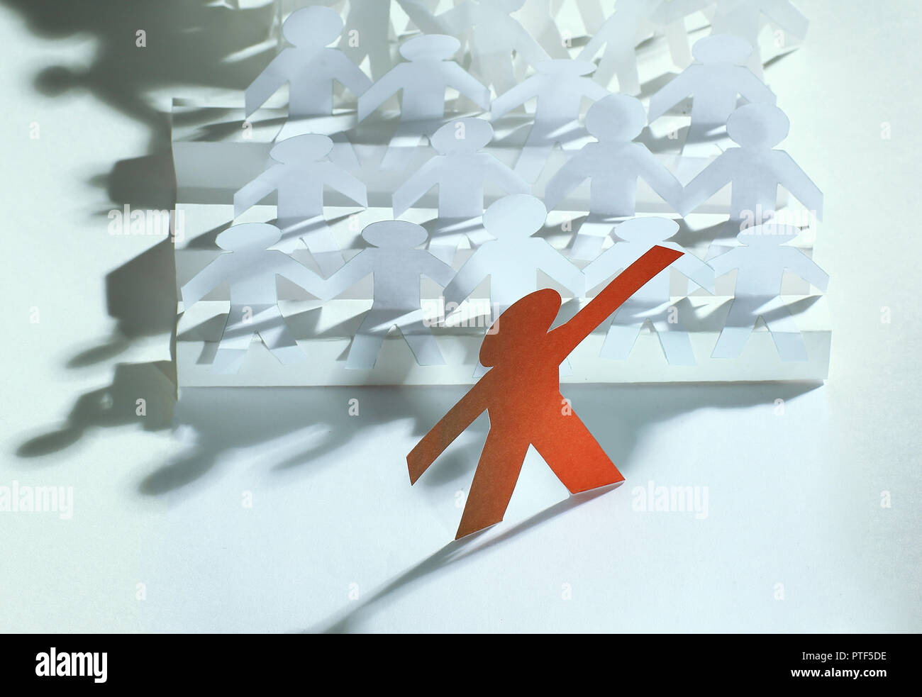 leader standing in front of a group of paper doll Stock Photo - Alamy