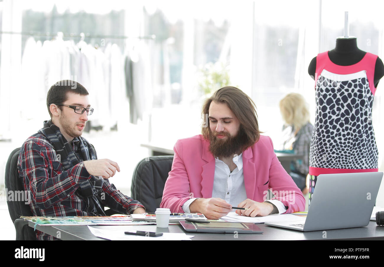 two fashion designers discussing designs of the new models Stock Photo ...