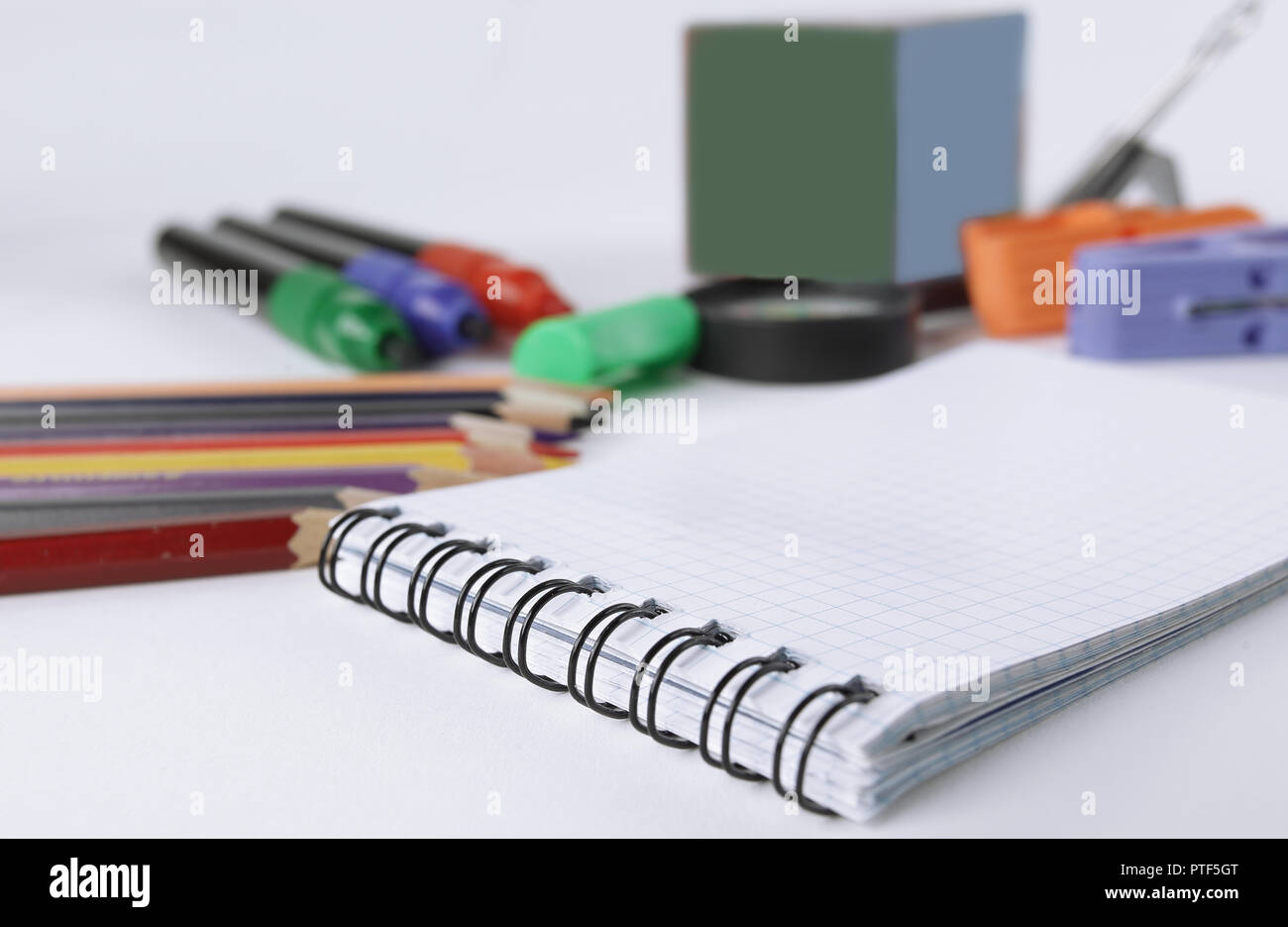 Notepad and blurred image of office supplies on white background Stock ...