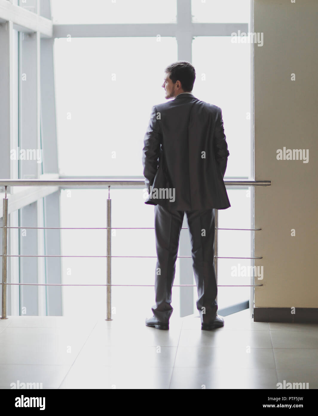 rear view. businessman standing in the lobby of a modern office Stock ...
