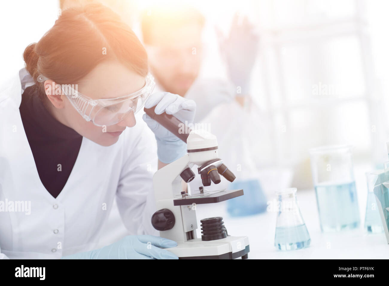 female scientists looking into a microscope Stock Photo - Alamy