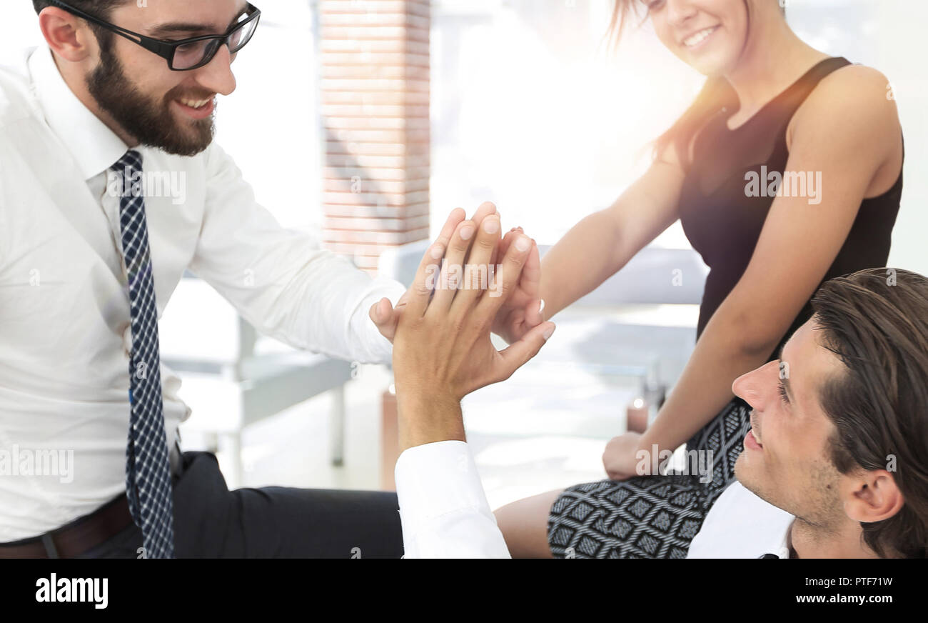 members of the business team give each other high five Stock Photo - Alamy