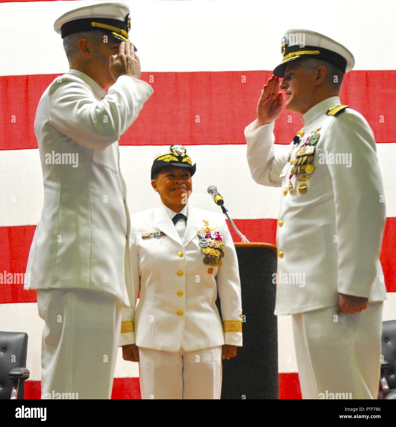 Capt. Philip Brock exchanges a final salute with Capt. Steve Banta ...