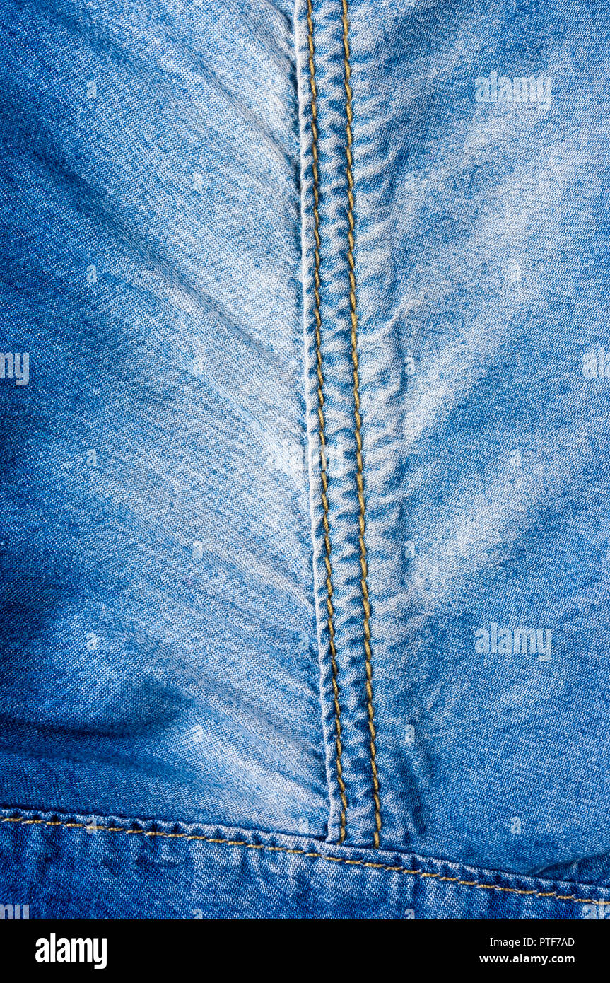 Blue washed faded jeans texture with seams, clothing items, macro ...