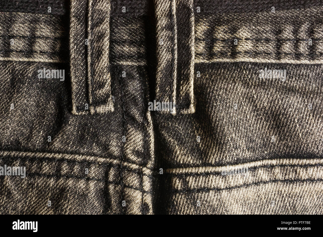 Black washed faded jeans texture with seams, clothing items, macro ...