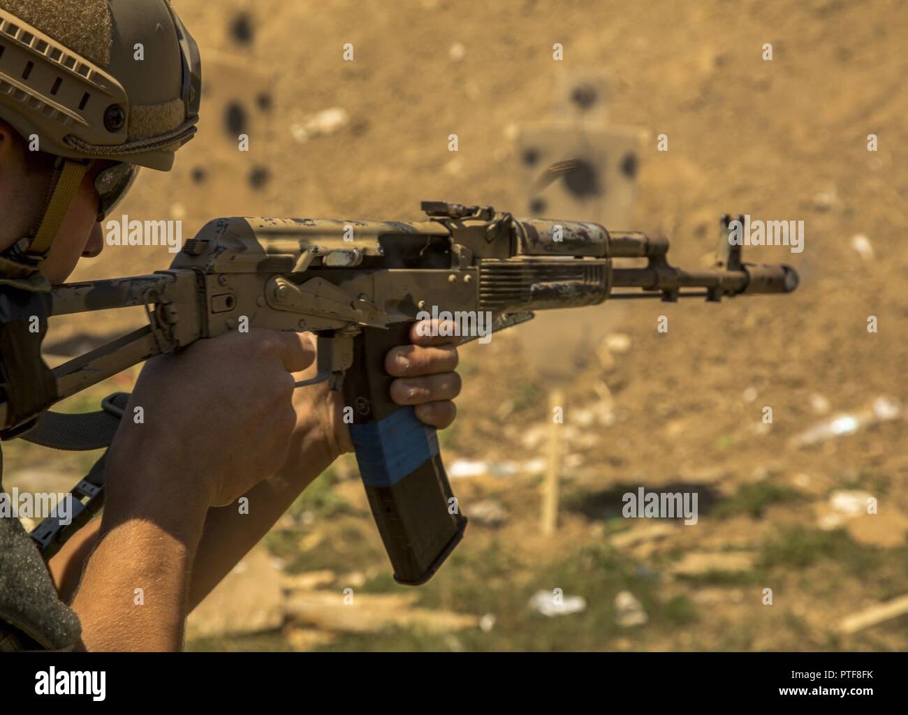 A Ukrainian SOF Operator fires and AK-47 Assault Rifle during training ...