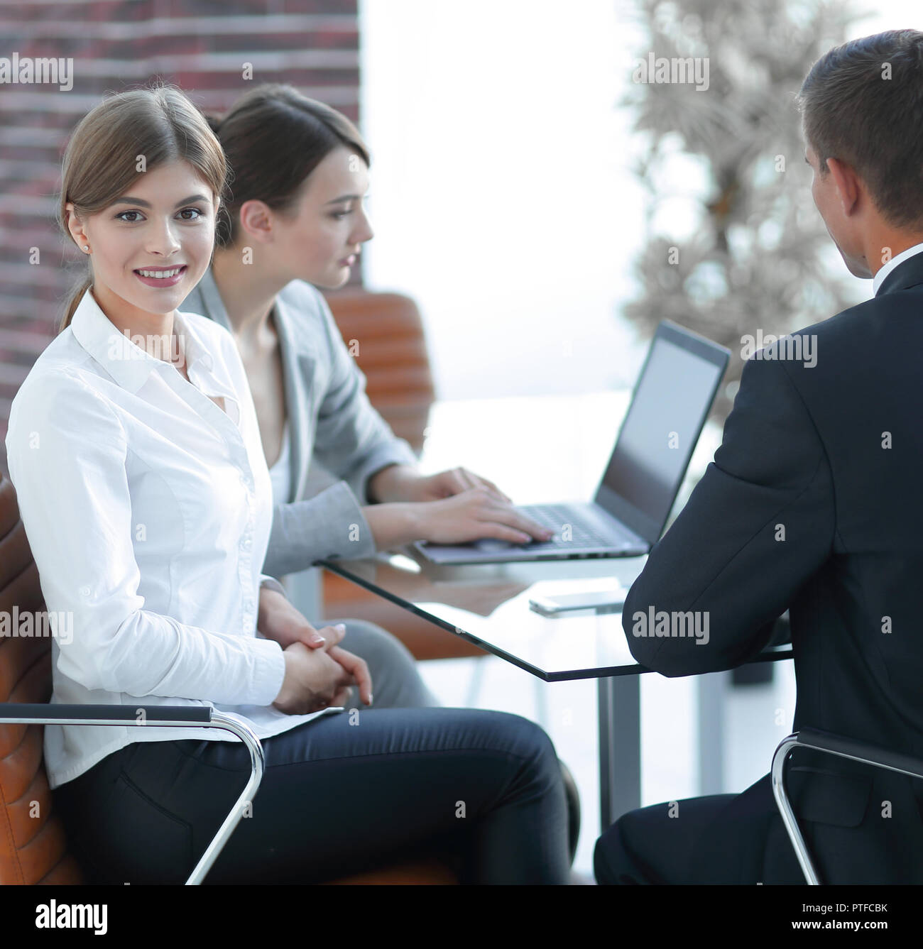 office workers sitting behind a Desk Stock Photo - Alamy