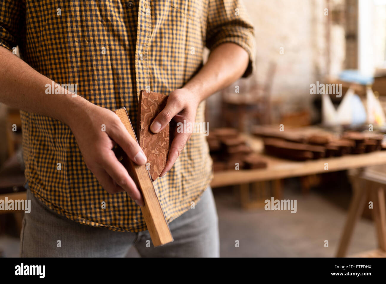 Hands of a wood carpenter Stock Photo - Alamy
