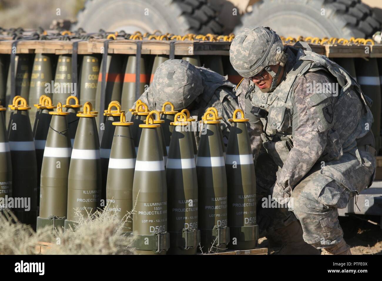 Illuminating projectiles, each weighing close to 100 pounds, are staged ...