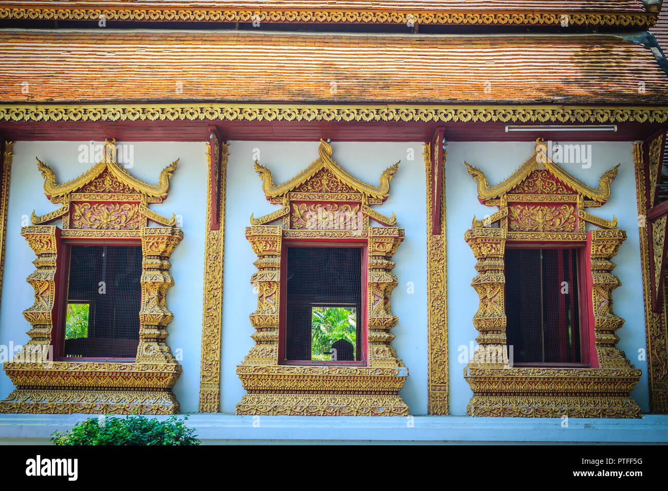 Beautiful golden window frames with white cement background in Thai ...