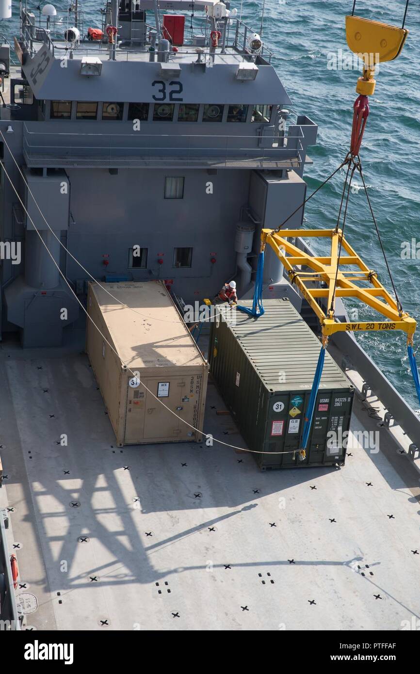 US Army Soldiers on a Landing Craft Utility (LCU) 2000 attach a 20 foot ...