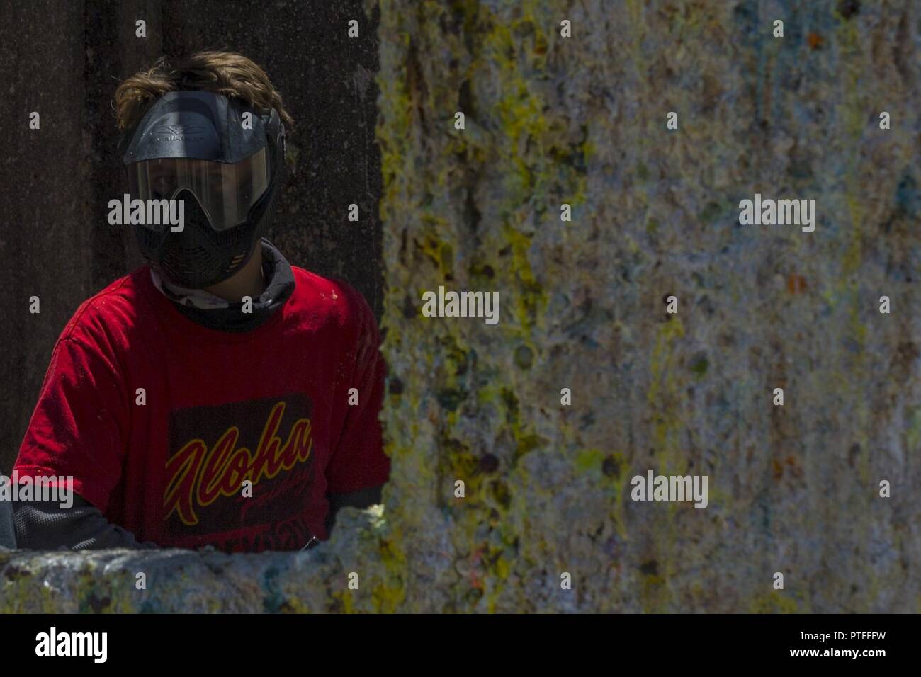Gavin Kolb, a participant in a game of capture the hill, takes cover ...