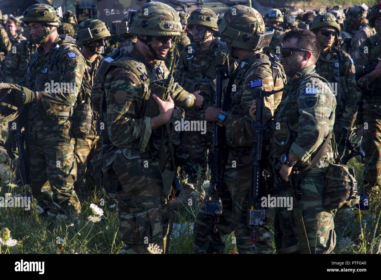 Infantry from the Greek Army prep their gear prior to an air assault ...