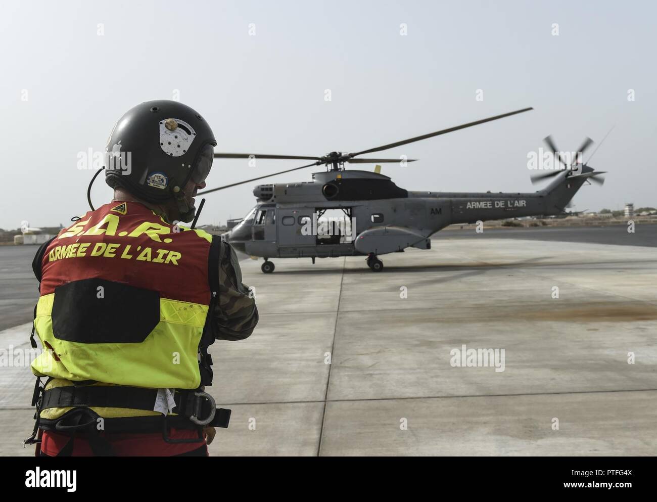 A member of the French Air Force Tactical Airlift Squadron 88 stands on ...