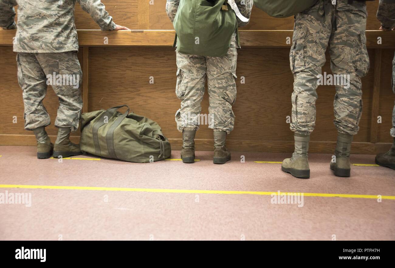 Airmen from the 4th Fighter Wing wait to have their mobility folders ...