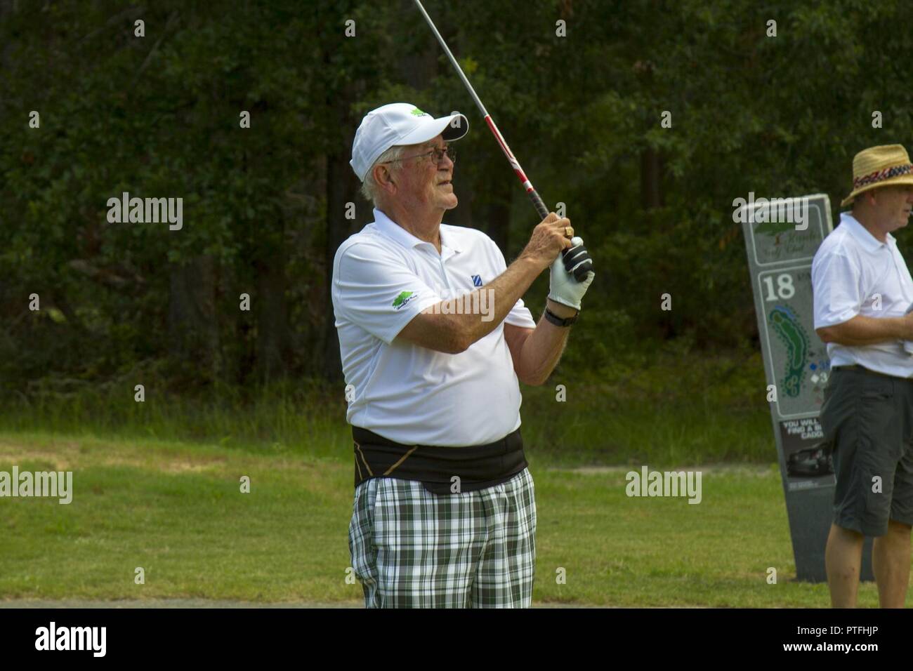 78-year-old Robin Christy watches as he hits a drive down the fairway ...