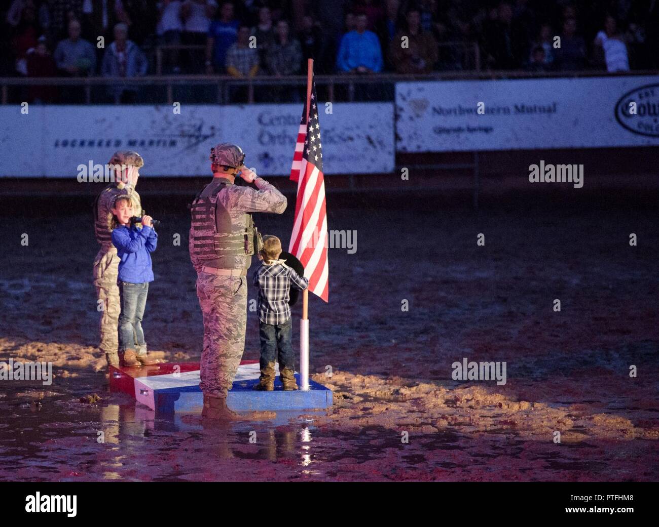 Airmen and two children of military members salute and say the Pledge ...