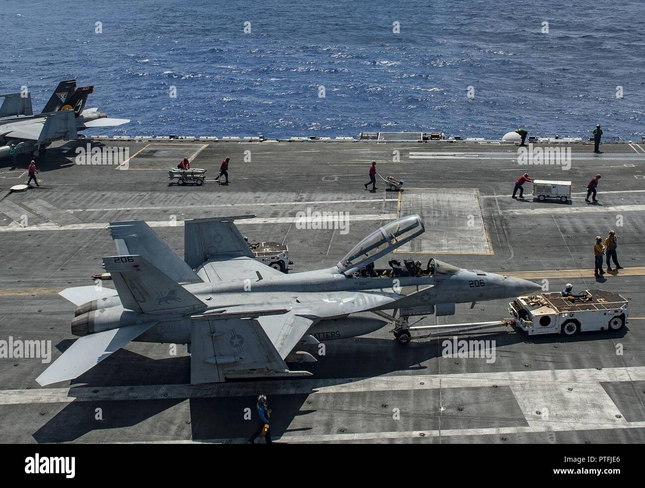 MEDITERRANEAN SEA (July 19, 2017) Sailors move ordnance and an F/A-18F ...
