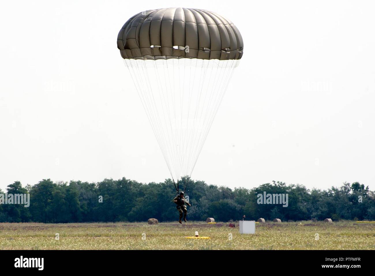 A paratrooper parachutes onto an airfield July 21 in Szolnok, Hungary ...