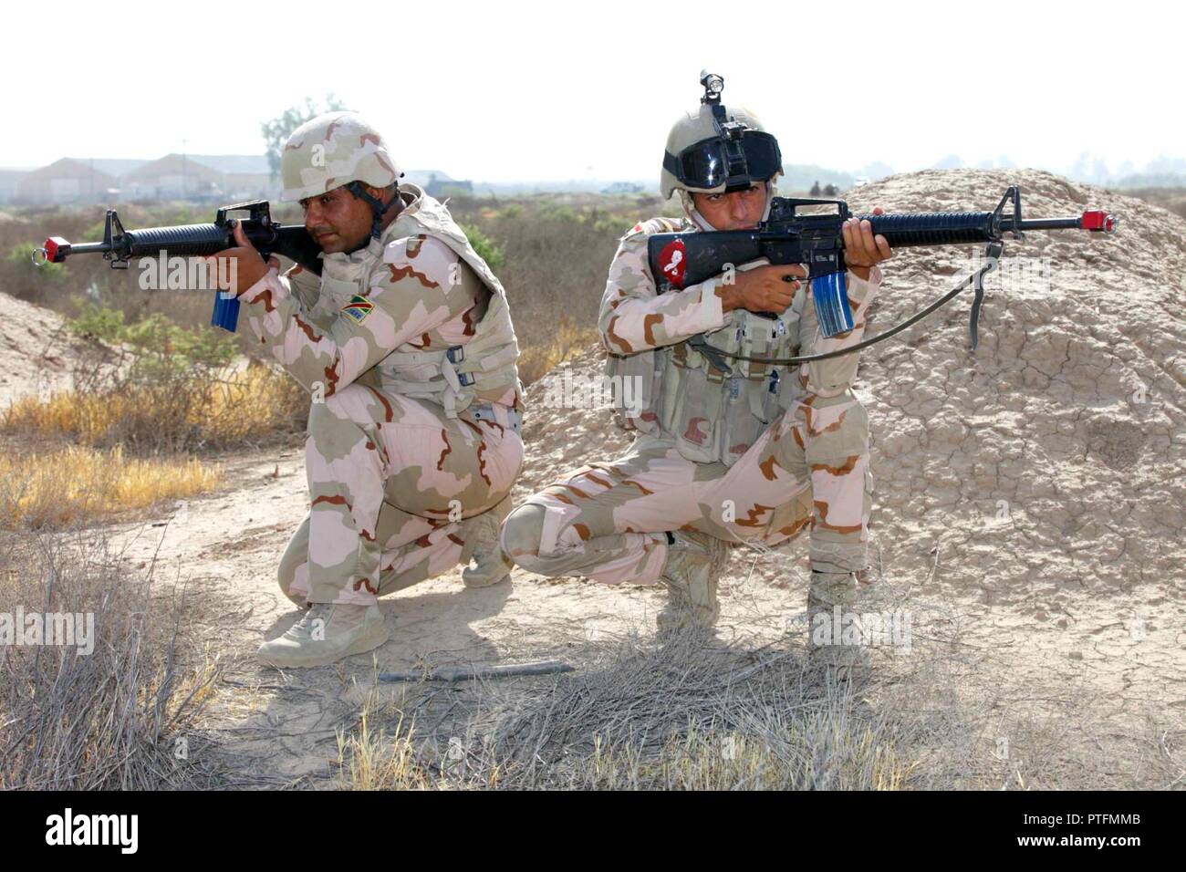 Iraqi army soldiers aim down the sights of their M16 rifle during rural ...