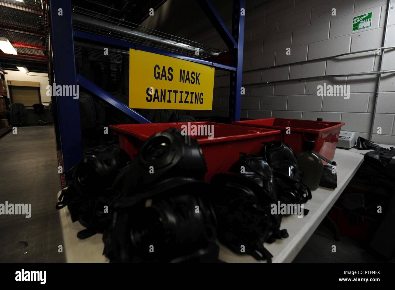 Gas masks are set in place before being put into a sanitizing solution ...